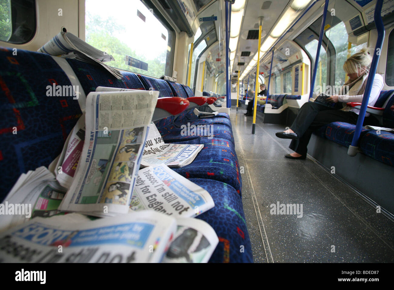 Newspapers left on on a London Underground tube train Stock Photo - Alamy
