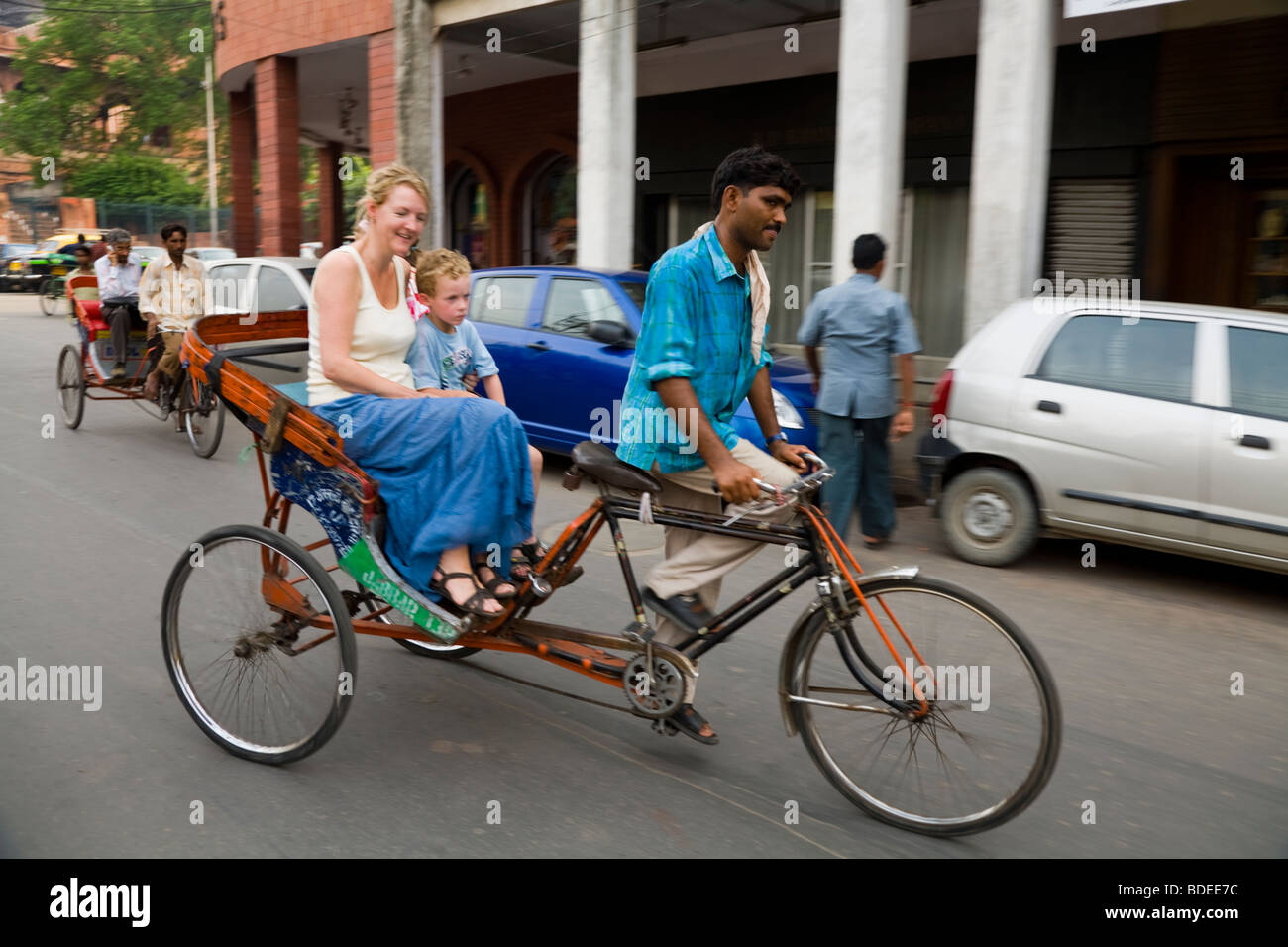 European / western woman and child taking a journey by cycle rickshaw ...