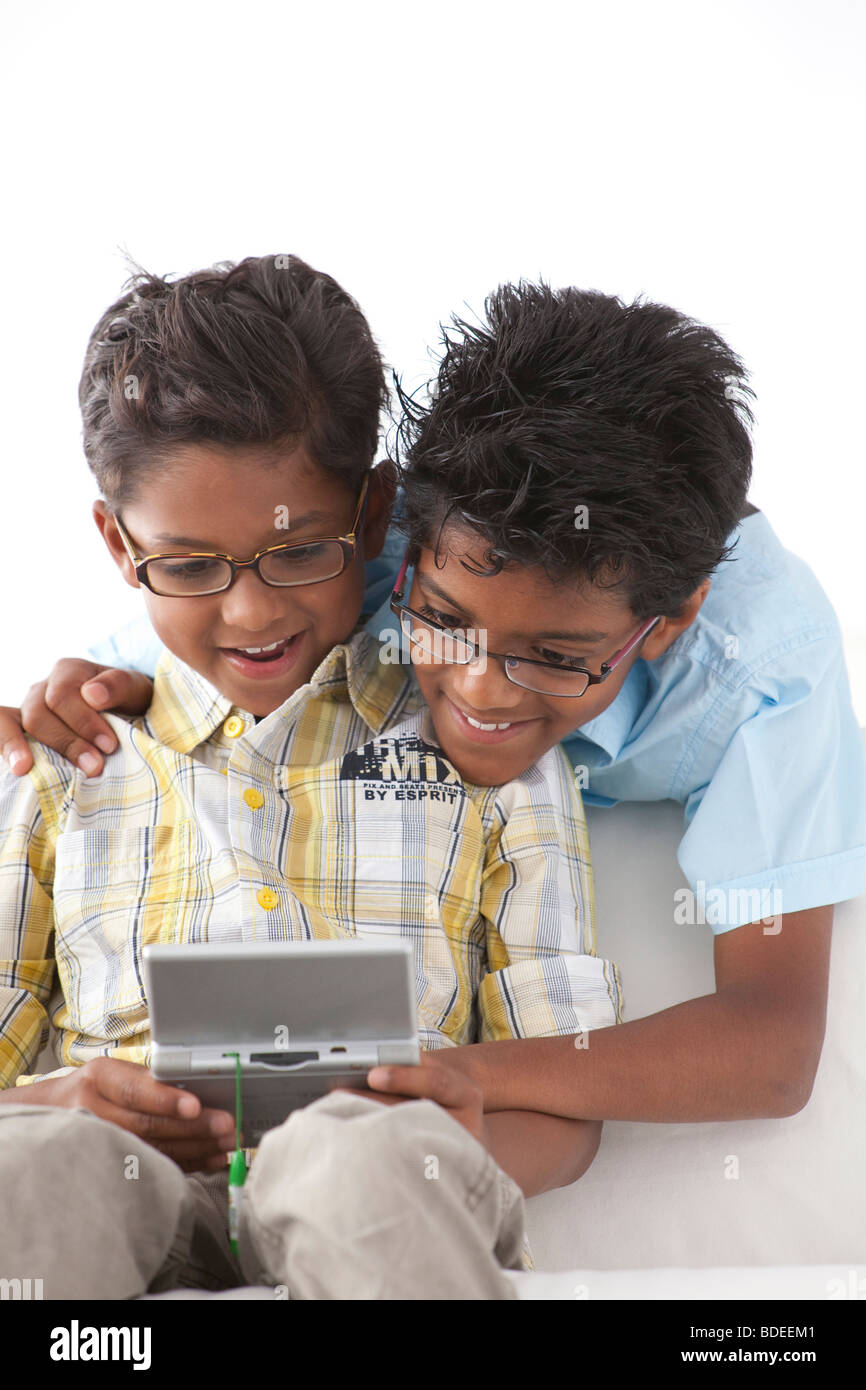 Two boys playing with a gameboy Stock Photo - Alamy