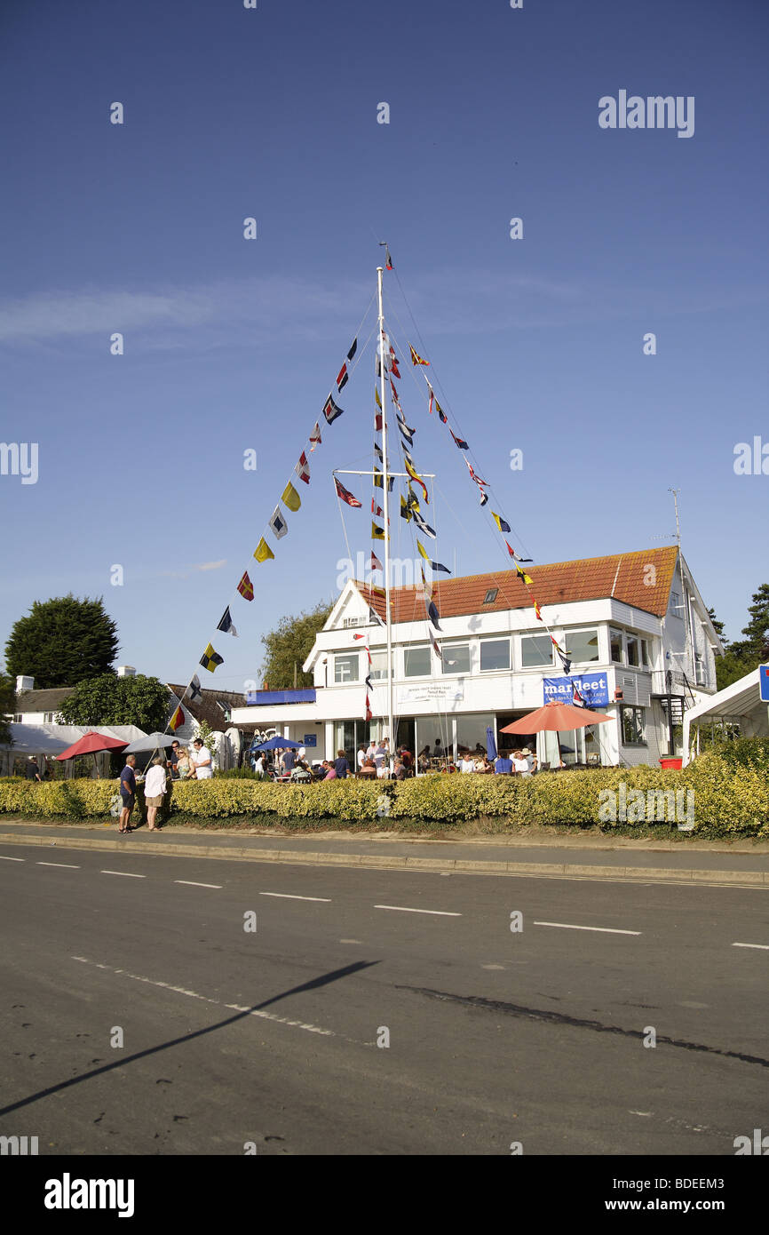 Sailing club house with regatta flags ensigns in blue sky landscape ...
