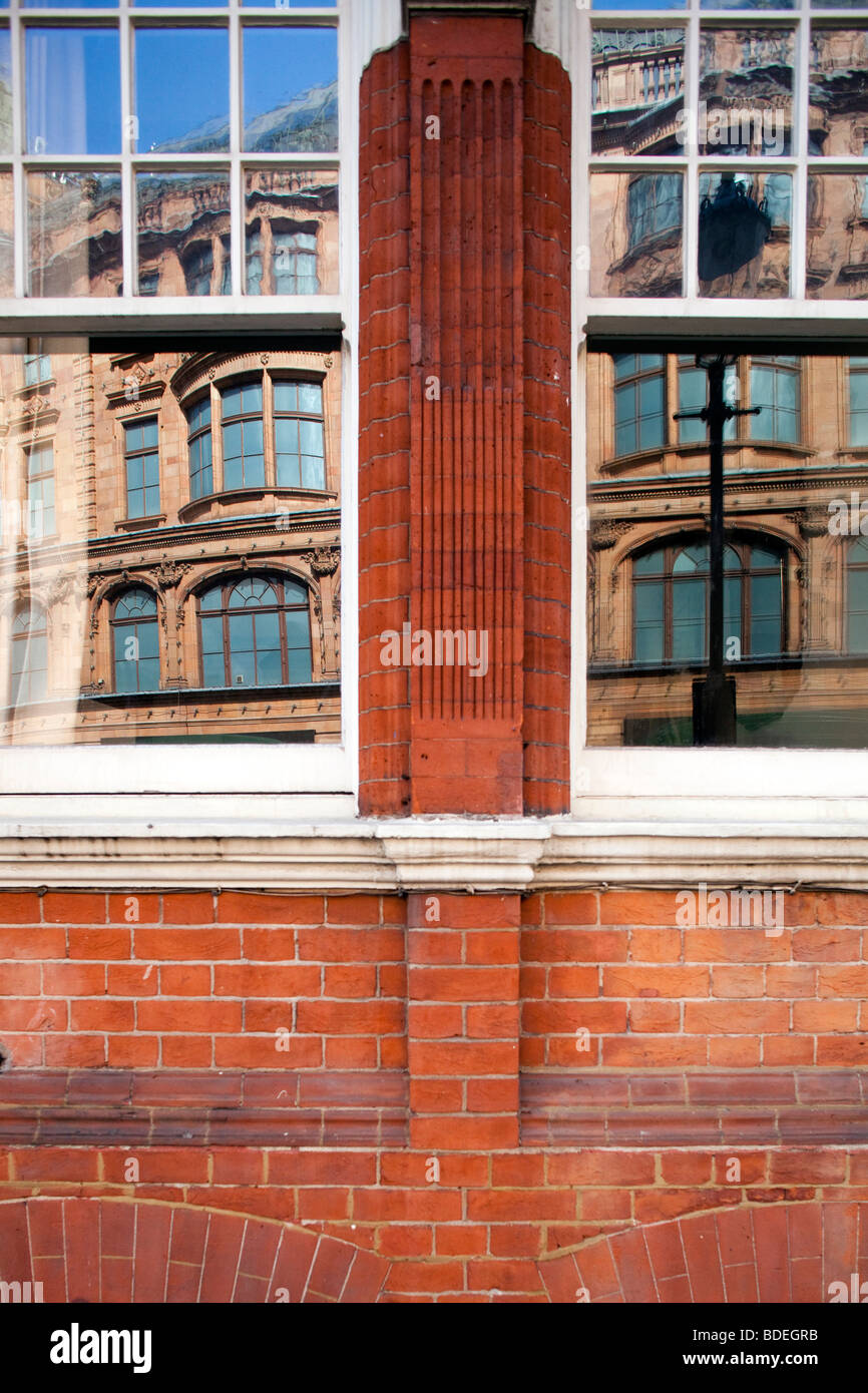 Harrods building reflected on an opposite building on Hans Road, London ...