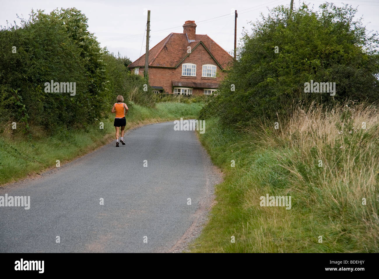 Lone female runner hi-res stock photography and images - Alamy