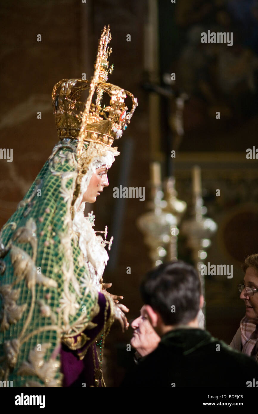 Old lady kissing Macarena Virgin's hand, Macarena Basilica, Seville ...