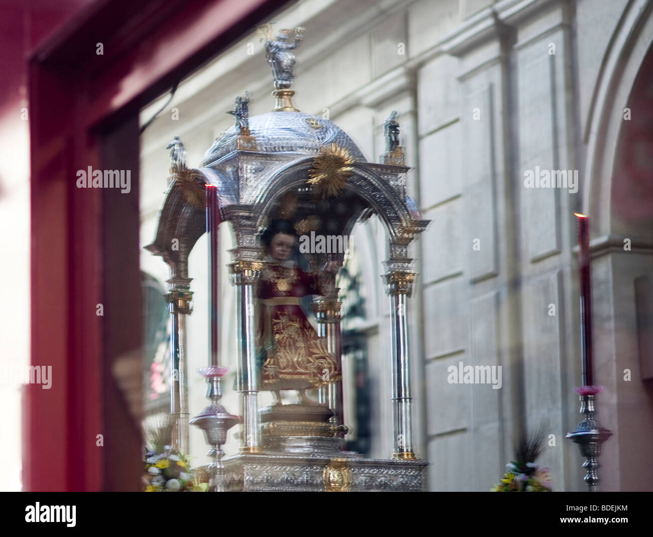 Silver float with Baby Jesus reflected on a shop window, Corpus Christi ...