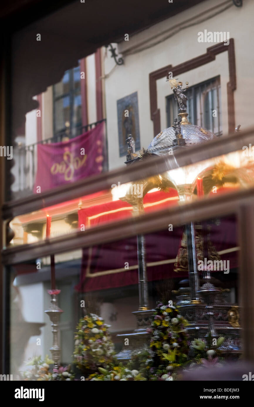 Silver float with Baby Jesus reflected on a shop window, Corpus Christi ...