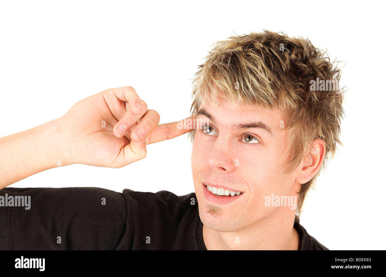 Close-up of teenage boy pointing at head against white background Stock ...