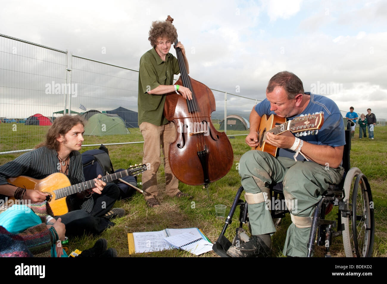 Three acoustic jazz musicians - one a disabled man in wheelchair ...