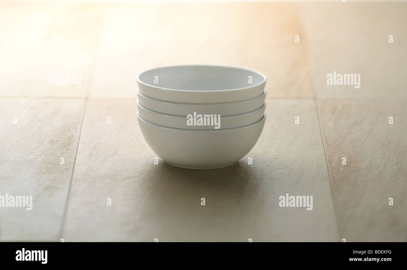 White bowls sitting on work surface Stock Photo - Alamy