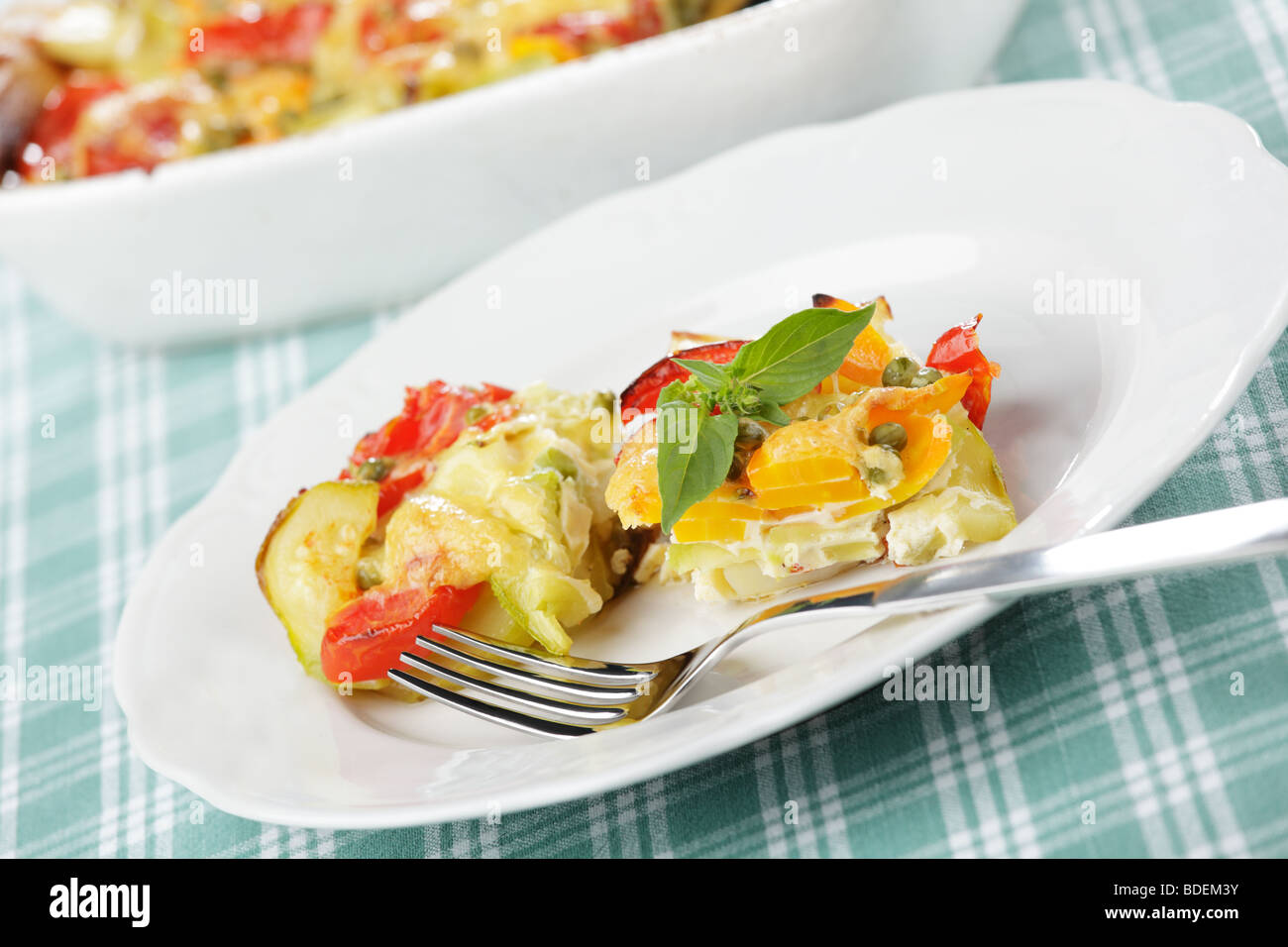 Vegetable baked pudding on white plate Stock Photo - Alamy