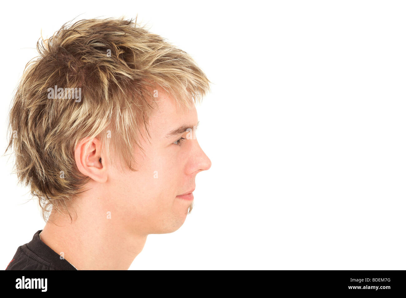 Side view of teenage boy against white background Stock Photo - Alamy