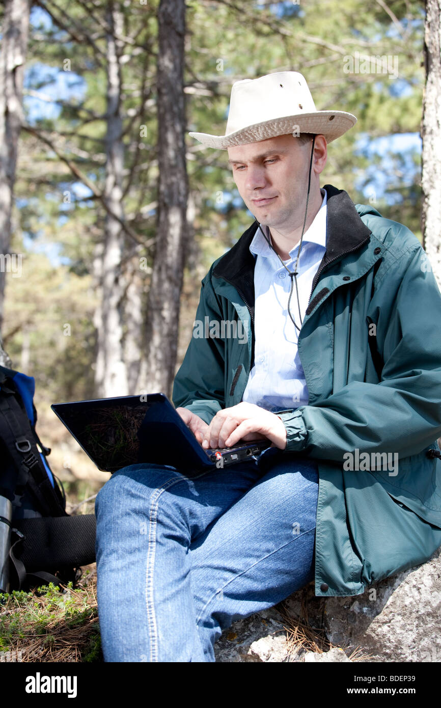 Man with laptop in forest Stock Photo - Alamy