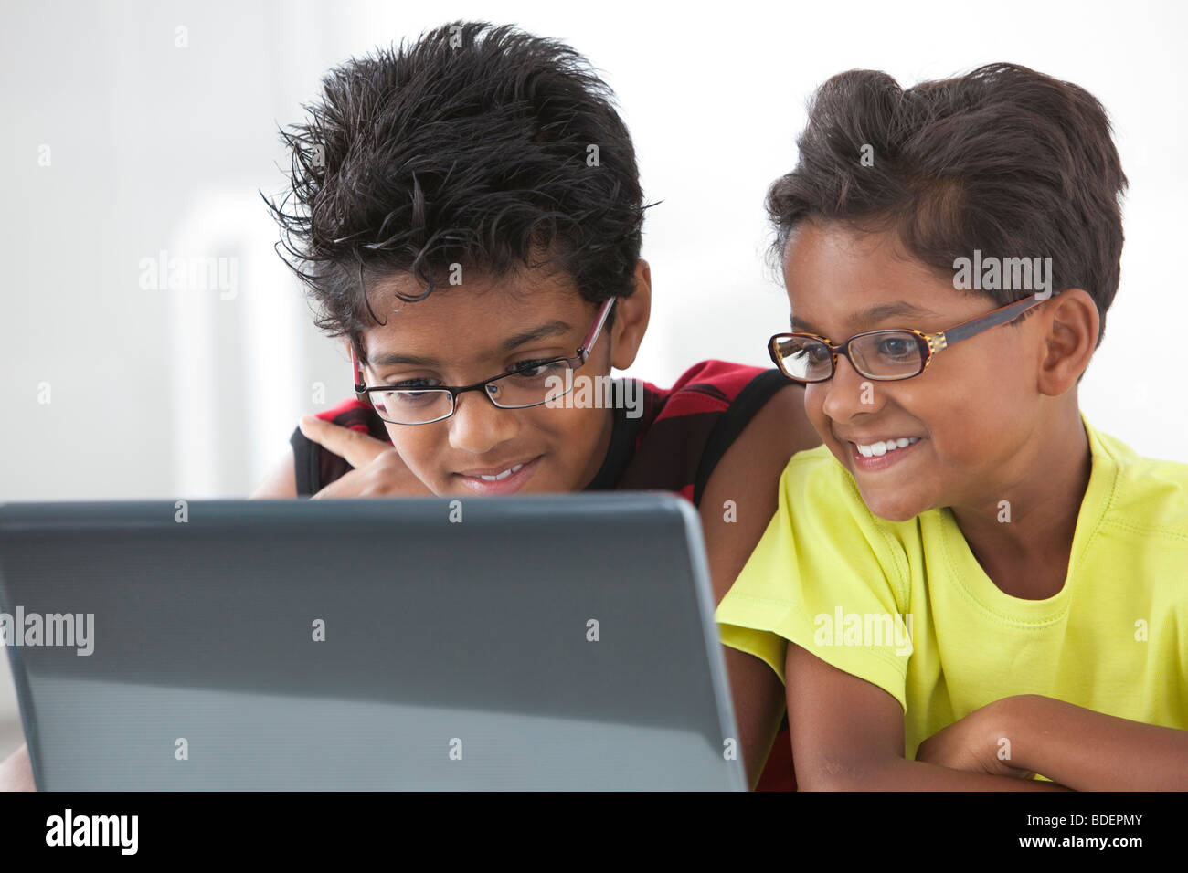 Two brothers behind a laptop Stock Photo - Alamy
