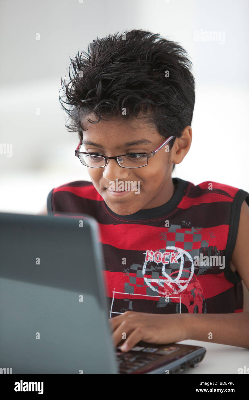 Teenage boy from Hindu origin behind a laptop Stock Photo - Alamy