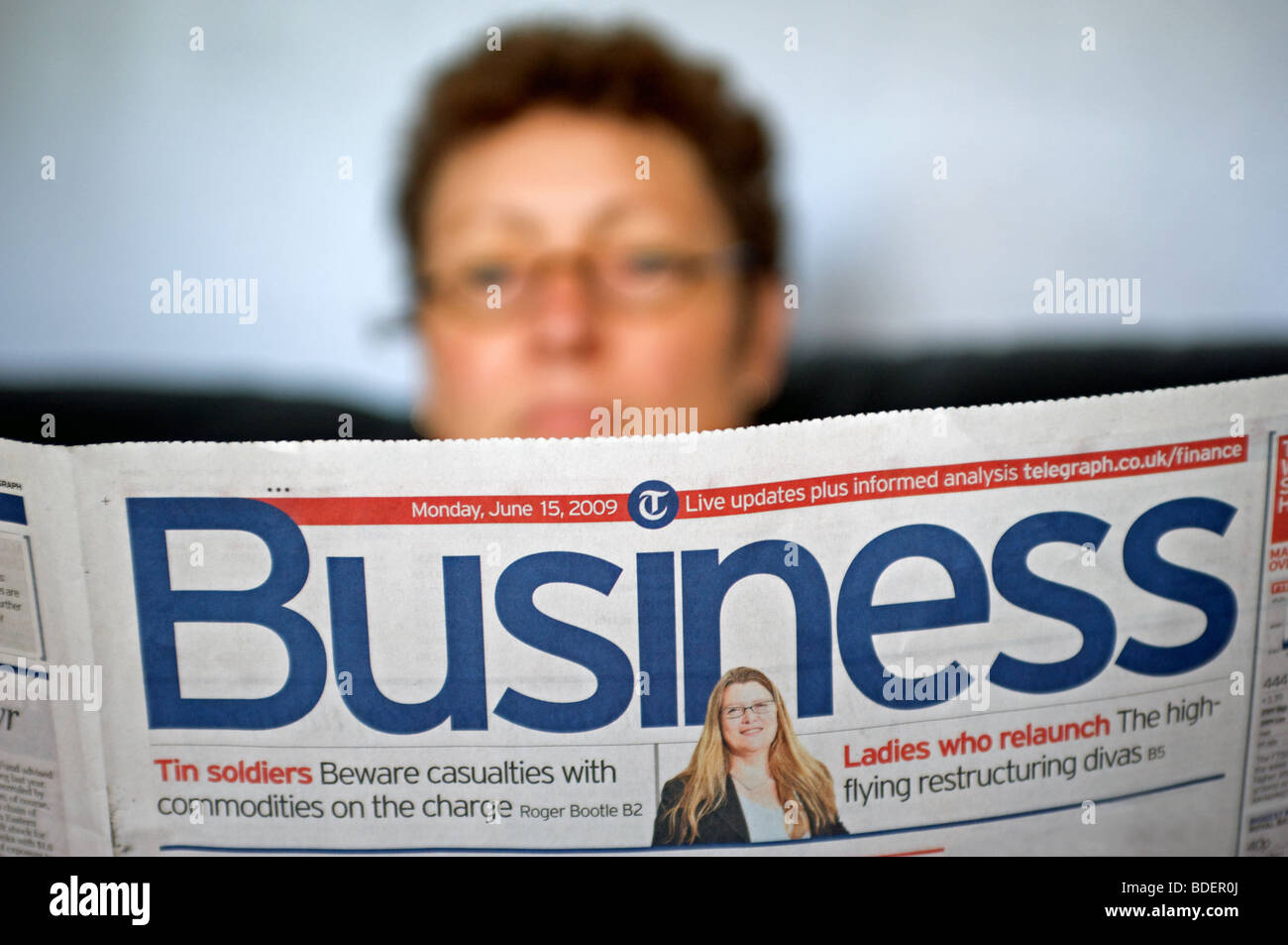 Woman reading the Daily Telegraph Business section Stock Photo - Alamy