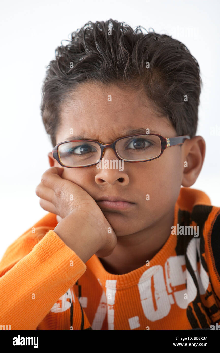 Portrait of a little boy from Hindu origin with an angry expression ...