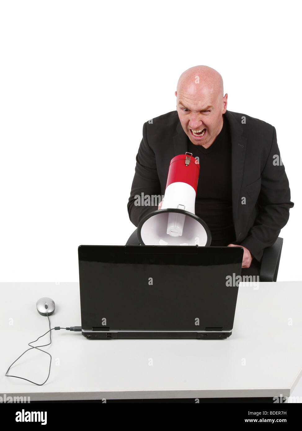 bald headed man screaming at laptop with megaphone Stock Photo - Alamy