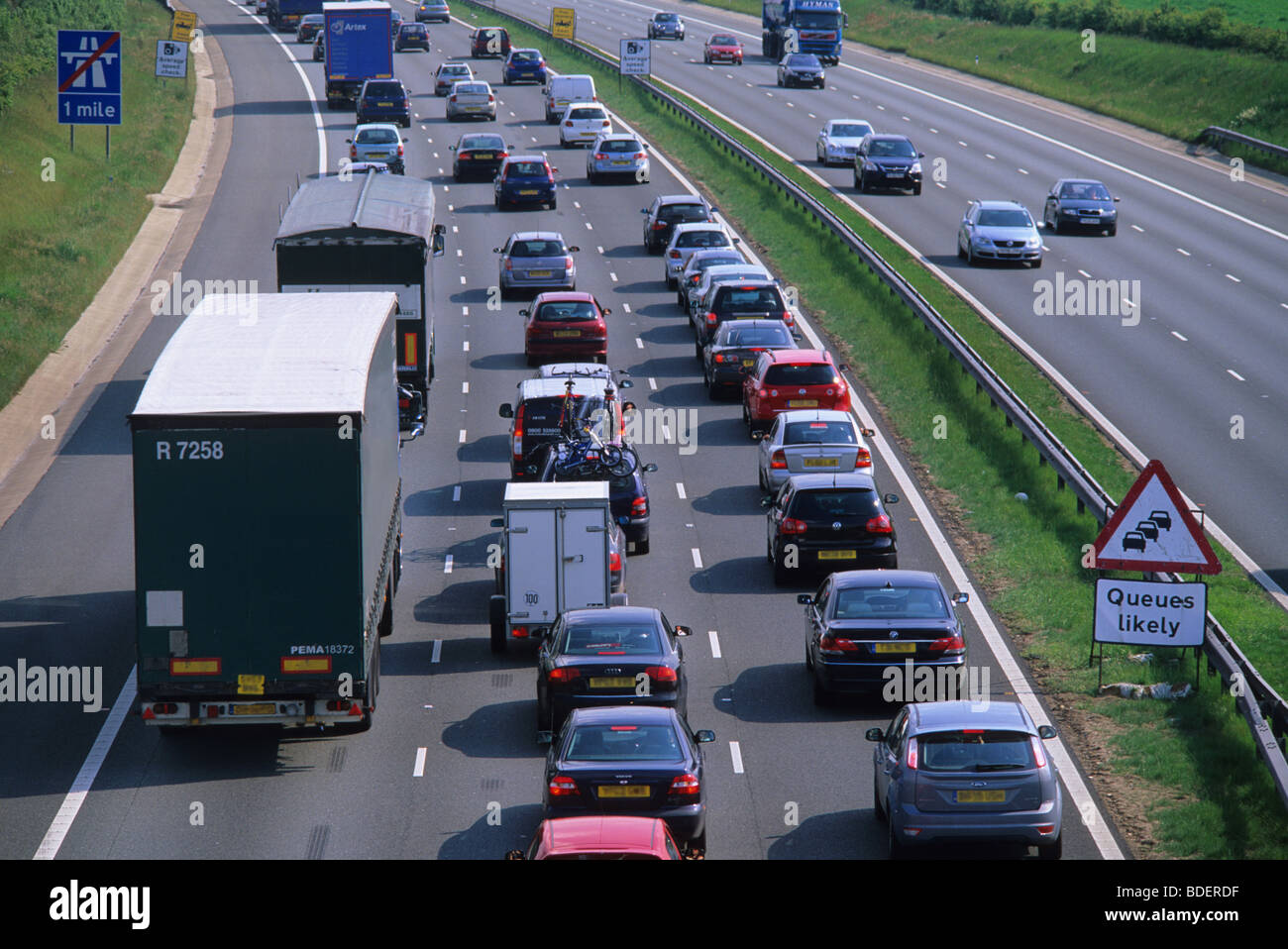 traffic jam at roadworks by sign warning of queuing vehicles on the A1 ...