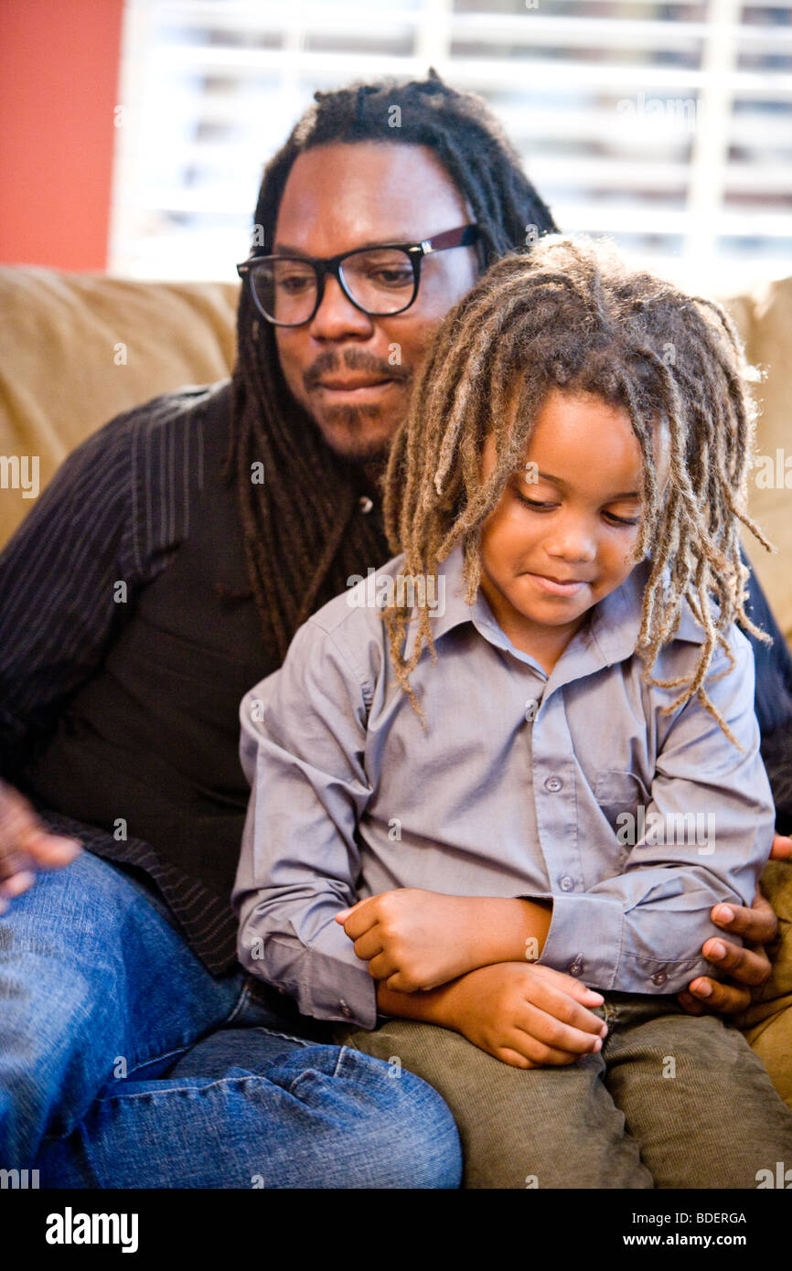 Portrait of Jamaican father and son with dreadlocks at home Stock Photo ...