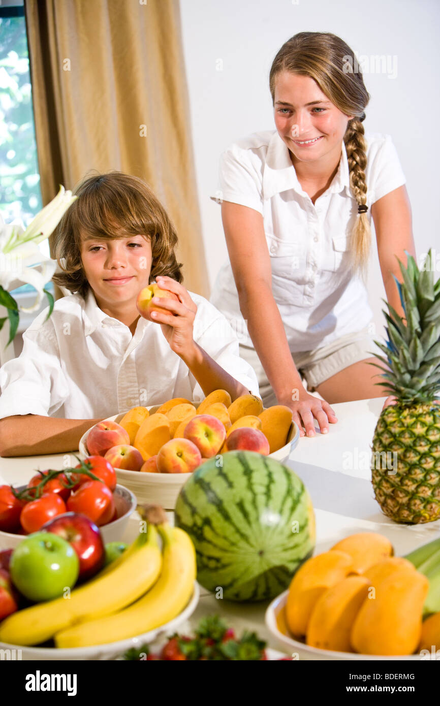Children in dining room with fruits and vegetables Stock Photo - Alamy