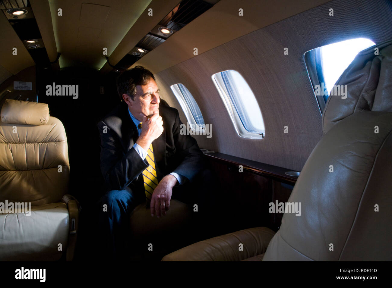 Businessman sitting in small private jet plane Stock Photo - Alamy