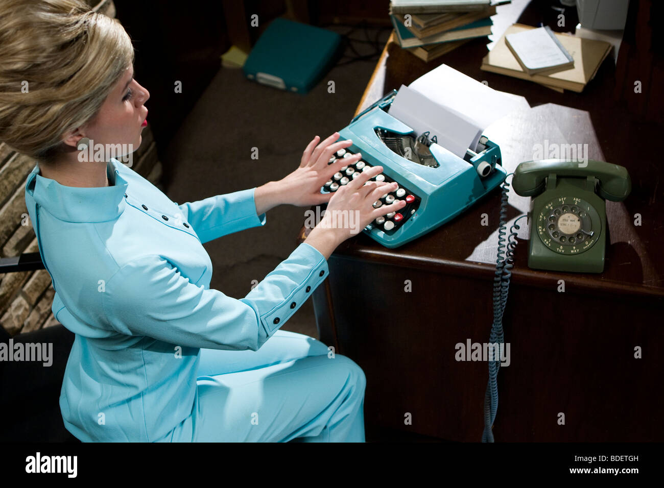 Vintage portrait of young secretary with beehive typing at desk Stock ...