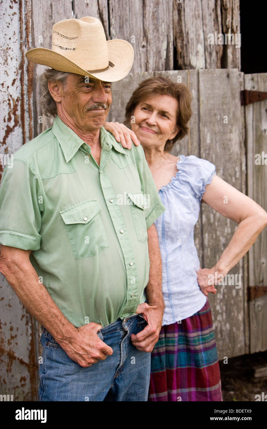 Portrait of senior couple standing outside barn Stock Photo - Alamy