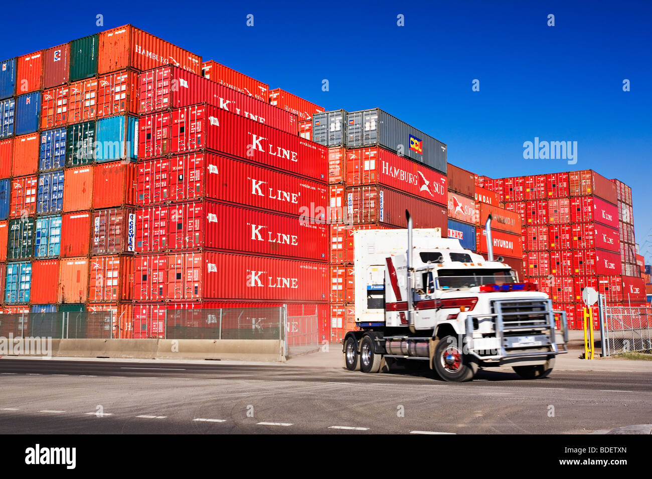 A semi-trailer truck hauls a container from a port container depot.The ...