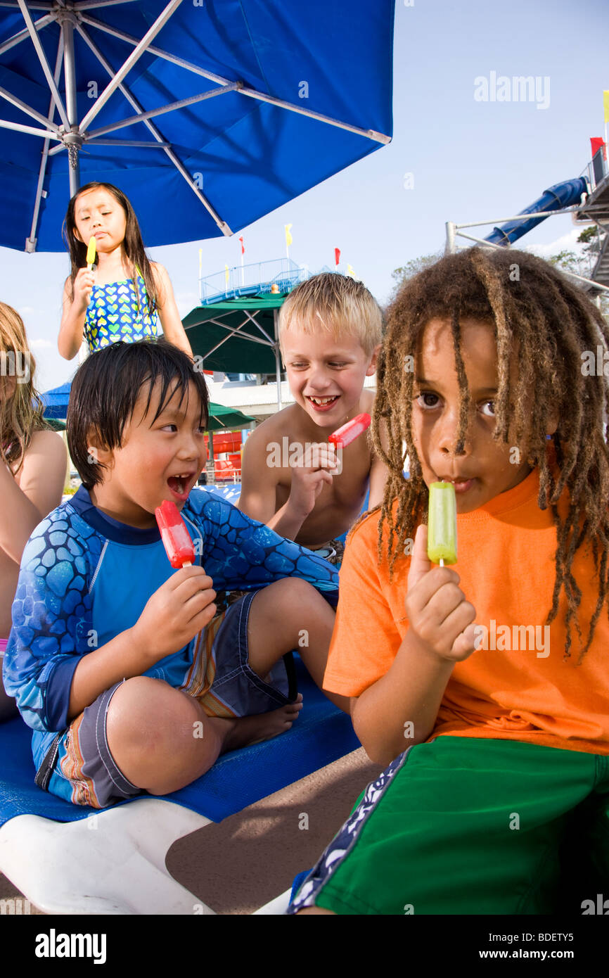 Multi-ethnic group of children eating popsicles Stock Photo - Alamy