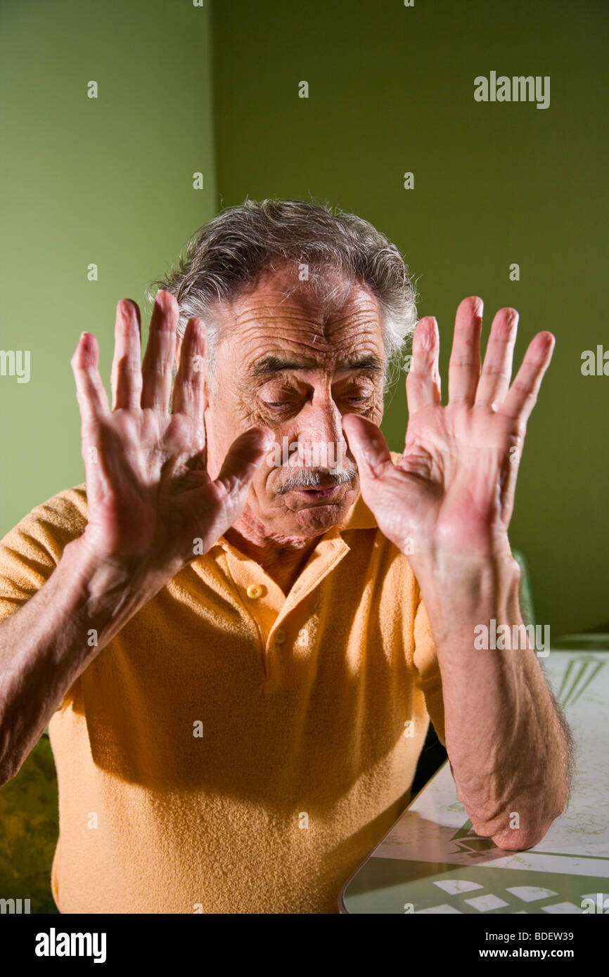 Senior man putting hands up in hesitation Stock Photo - Alamy