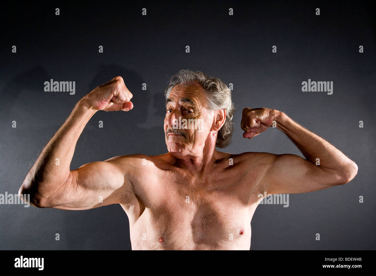 Senior Man Flexing Muscle Stock Photos & Senior Man Flexing Muscle ...