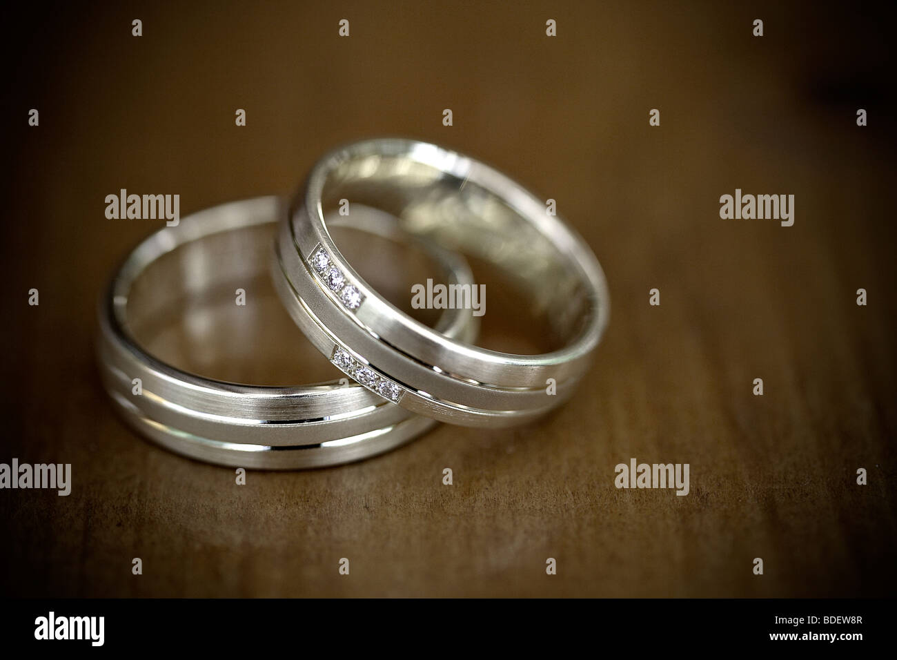 Pair of wedding rings, one overlapping the over Stock Photo - Alamy