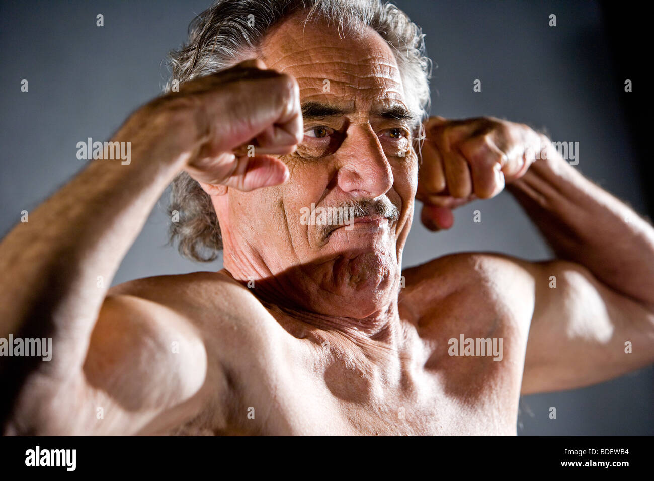 Senior Man Flexing Muscle Stock Photos & Senior Man Flexing Muscle ...