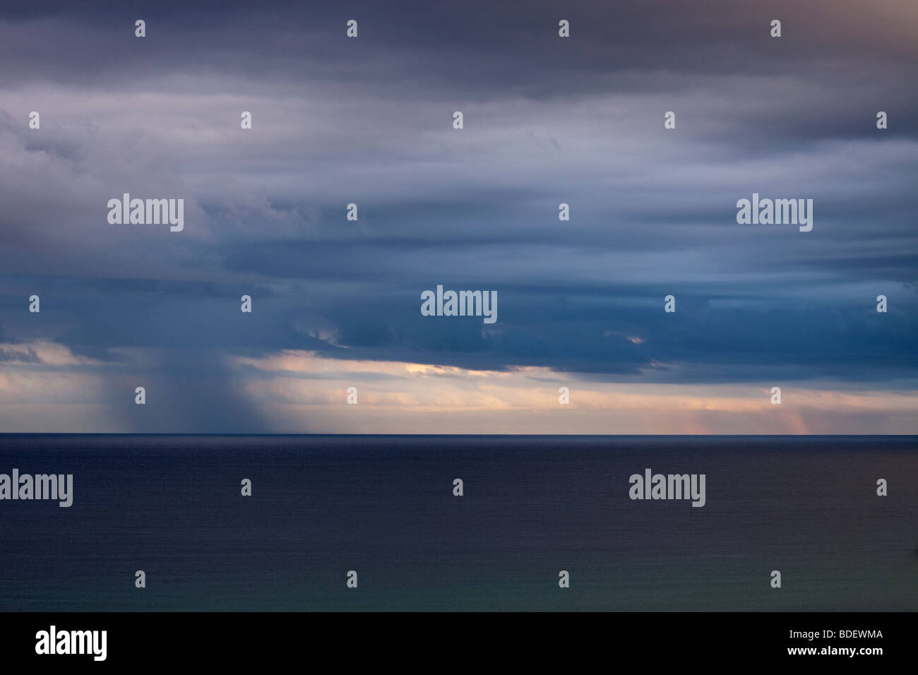 Rain falling on the ocean Stock Photo - Alamy