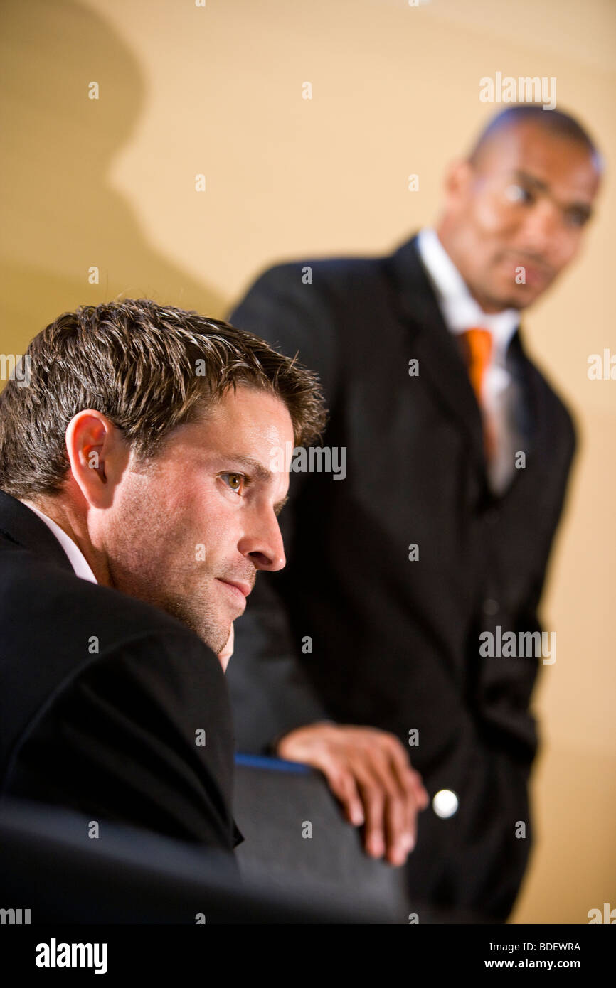 Profile of businessman, colleague standing in background Stock Photo ...