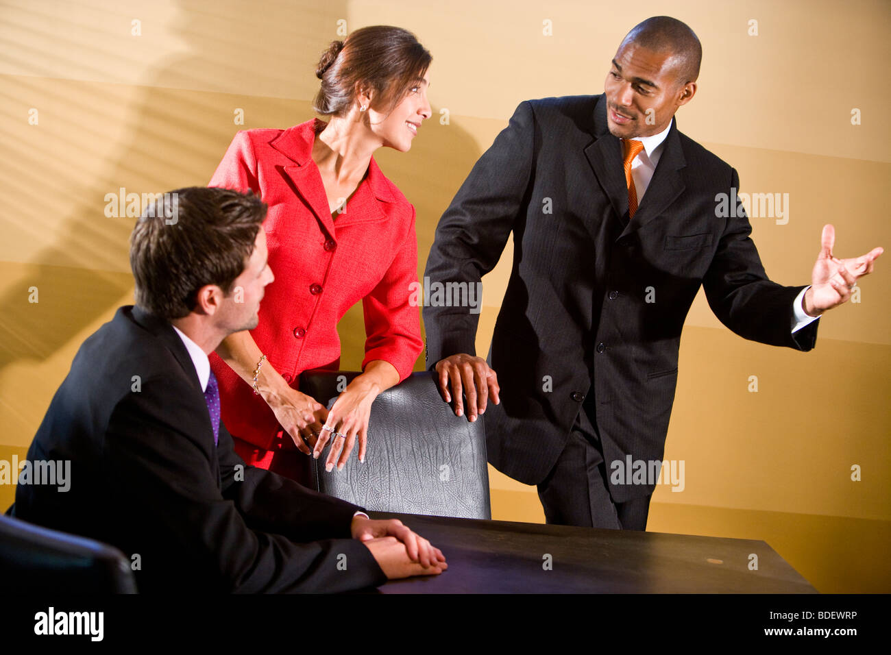 Multi-ethnic businesspeople talking in boardroom Stock Photo - Alamy
