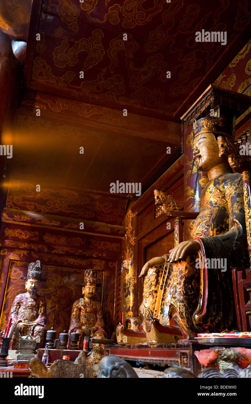 Richly-decorated interior of a temple with porcelain vases and a gold ...