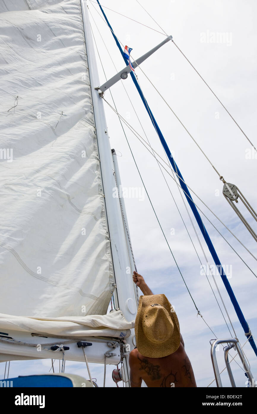 Man raising sails in the Gulf of Papagayo in Guanacaste, Costa Rica ...