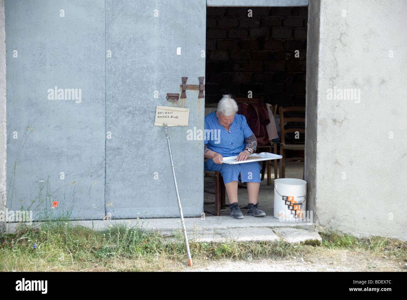 Old woman sorting lentils in the high plain town of Castelluccio in ...