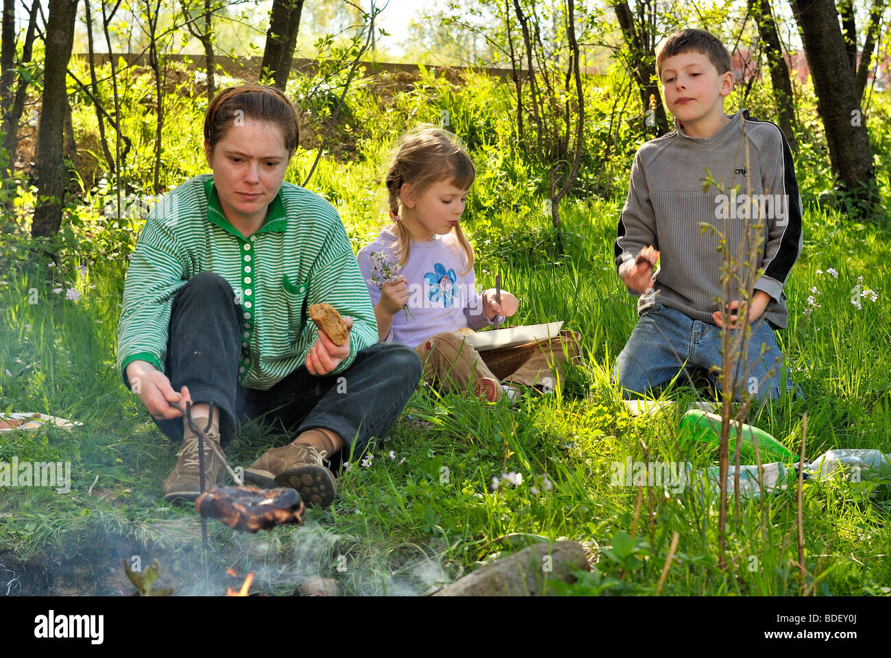 Family near campfire Stock Photo - Alamy