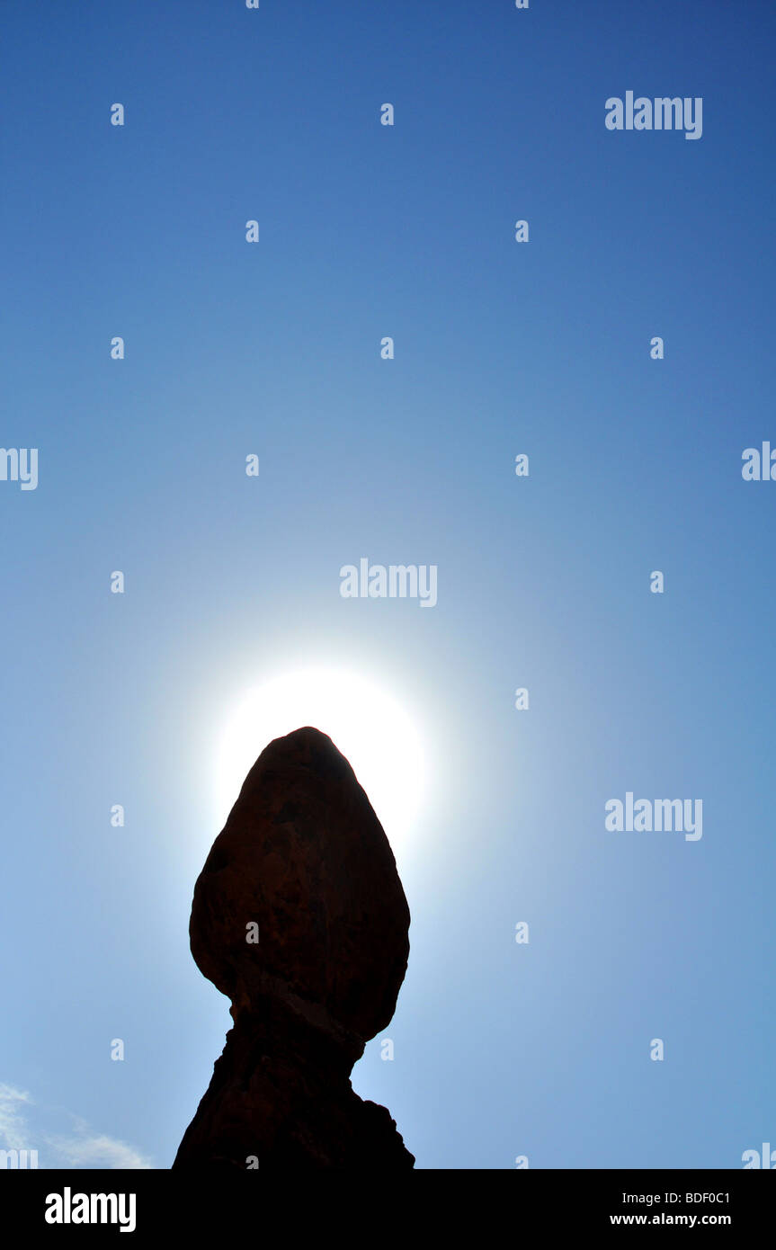 Sun eclipsed behind balanced rock formation in Arches National Park ...