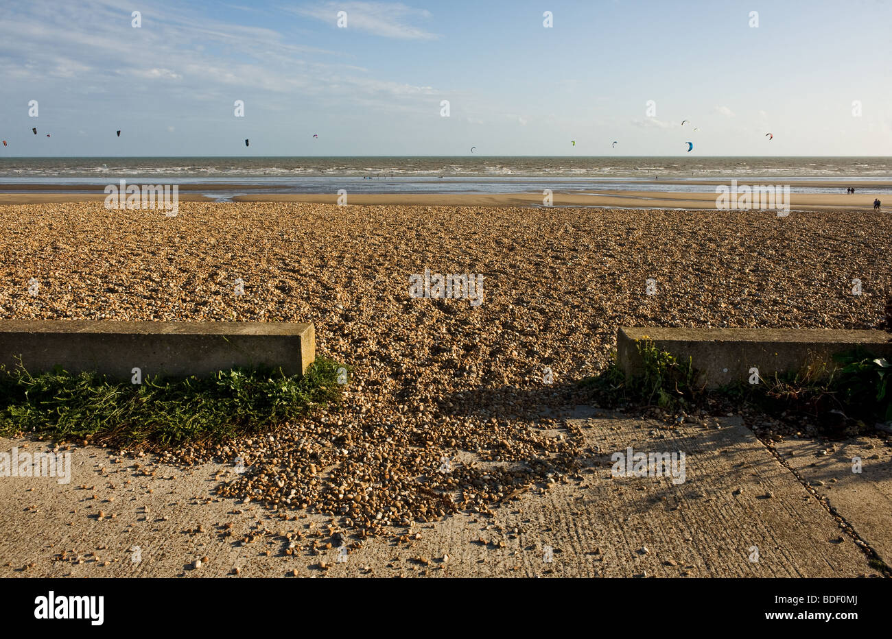 A gap in a concrete wall leading onto the shingle bank at Camber Sands ...