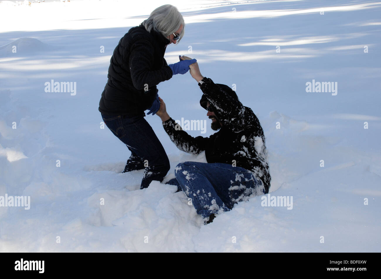 Snowy place of fun, families frolic and sledge near icy lake in soft ...