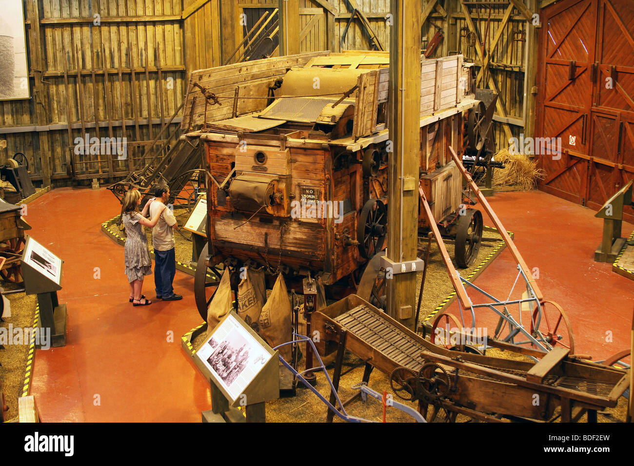 Old wooden combine harvester or threshing machine in a farming museum ...