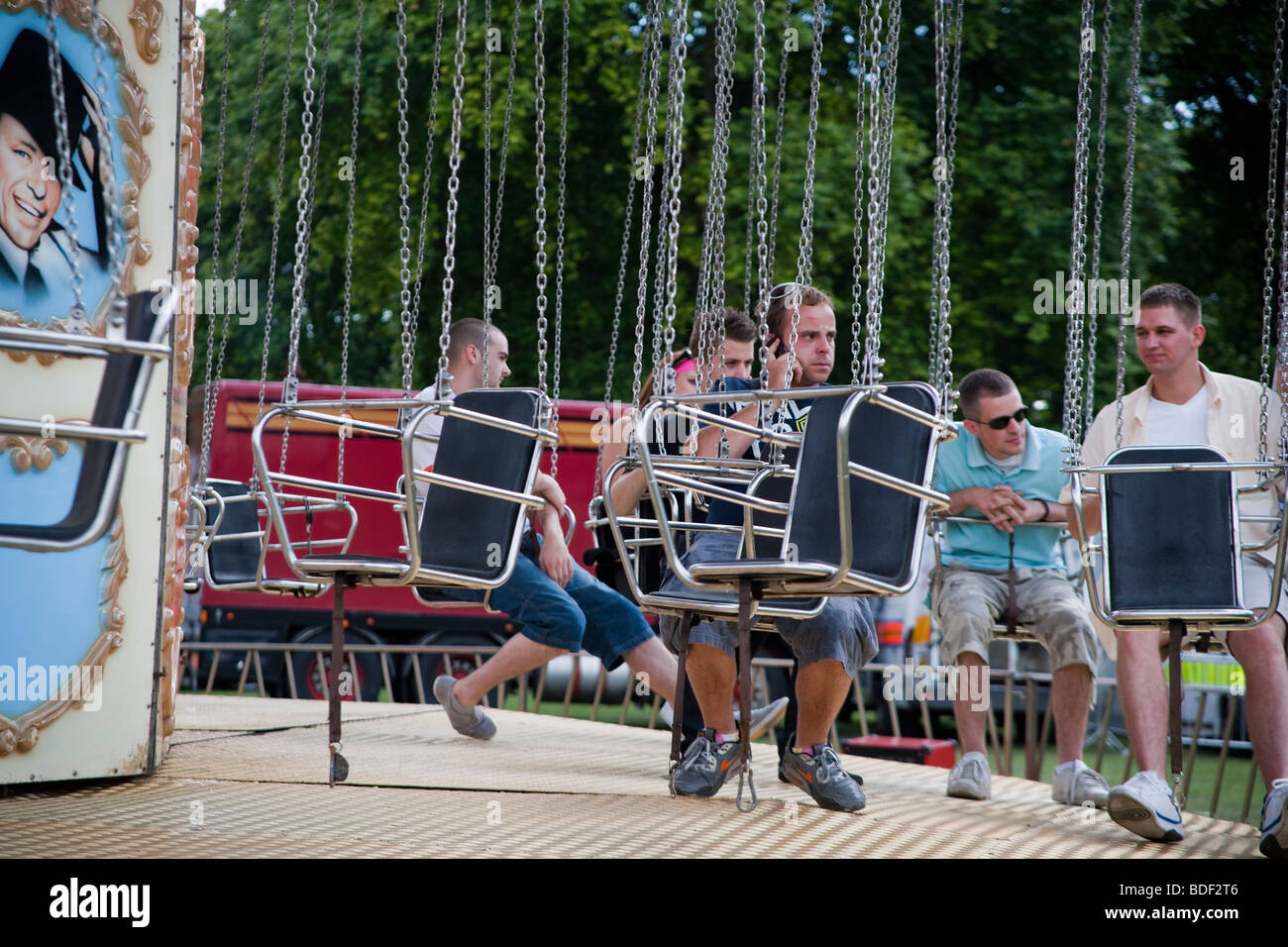 band concert crowd fun fair lake district swings tents young Stock Photo - Alamy