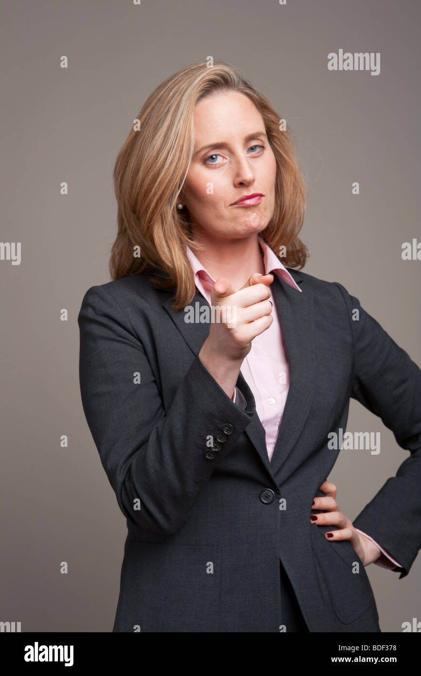 Businesswoman pointing with stern expression - focus on finger Stock ...