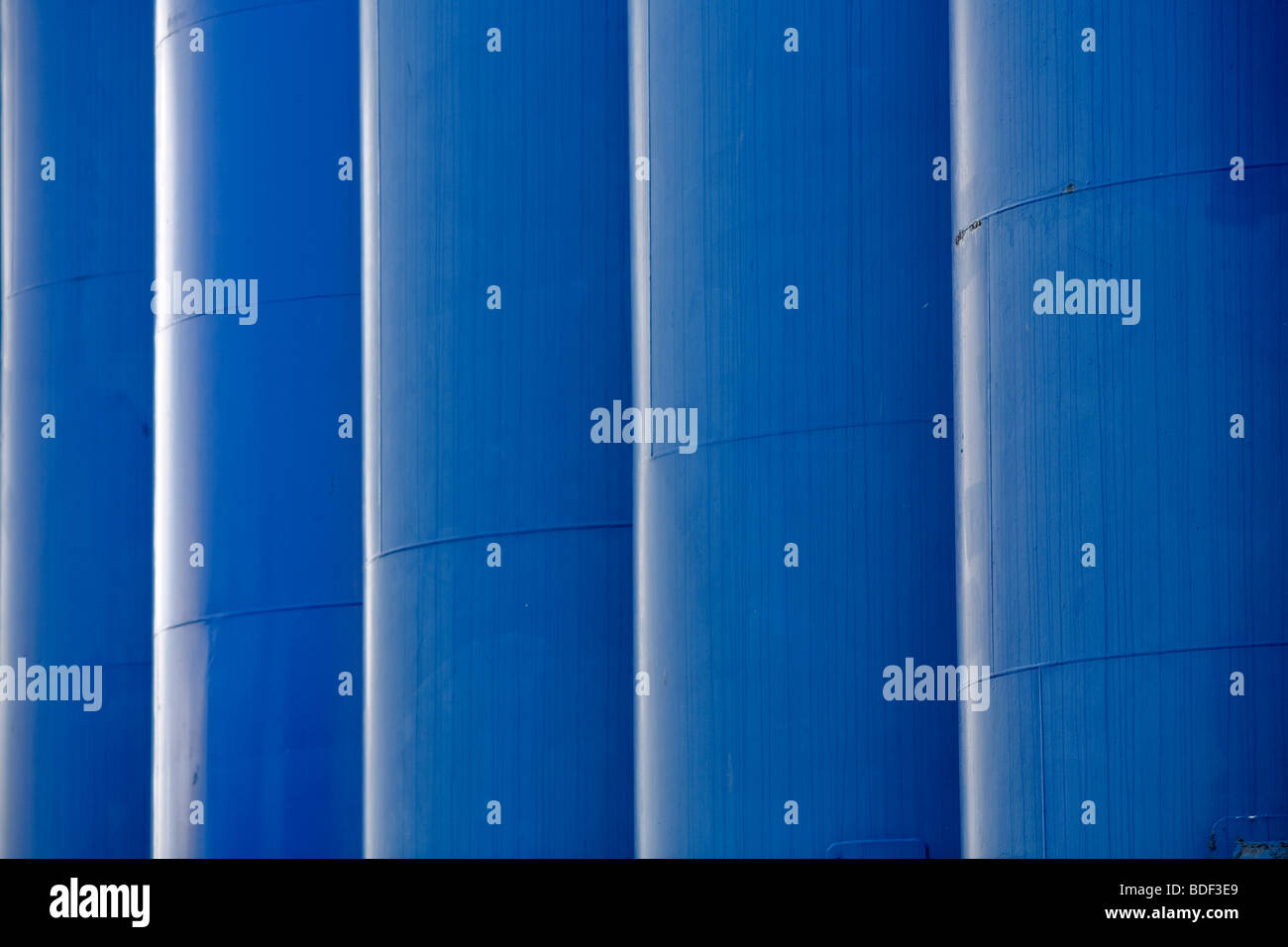 Abstract view of a raw of blue oil tanks - Aberdeen harbor - Scotland ...