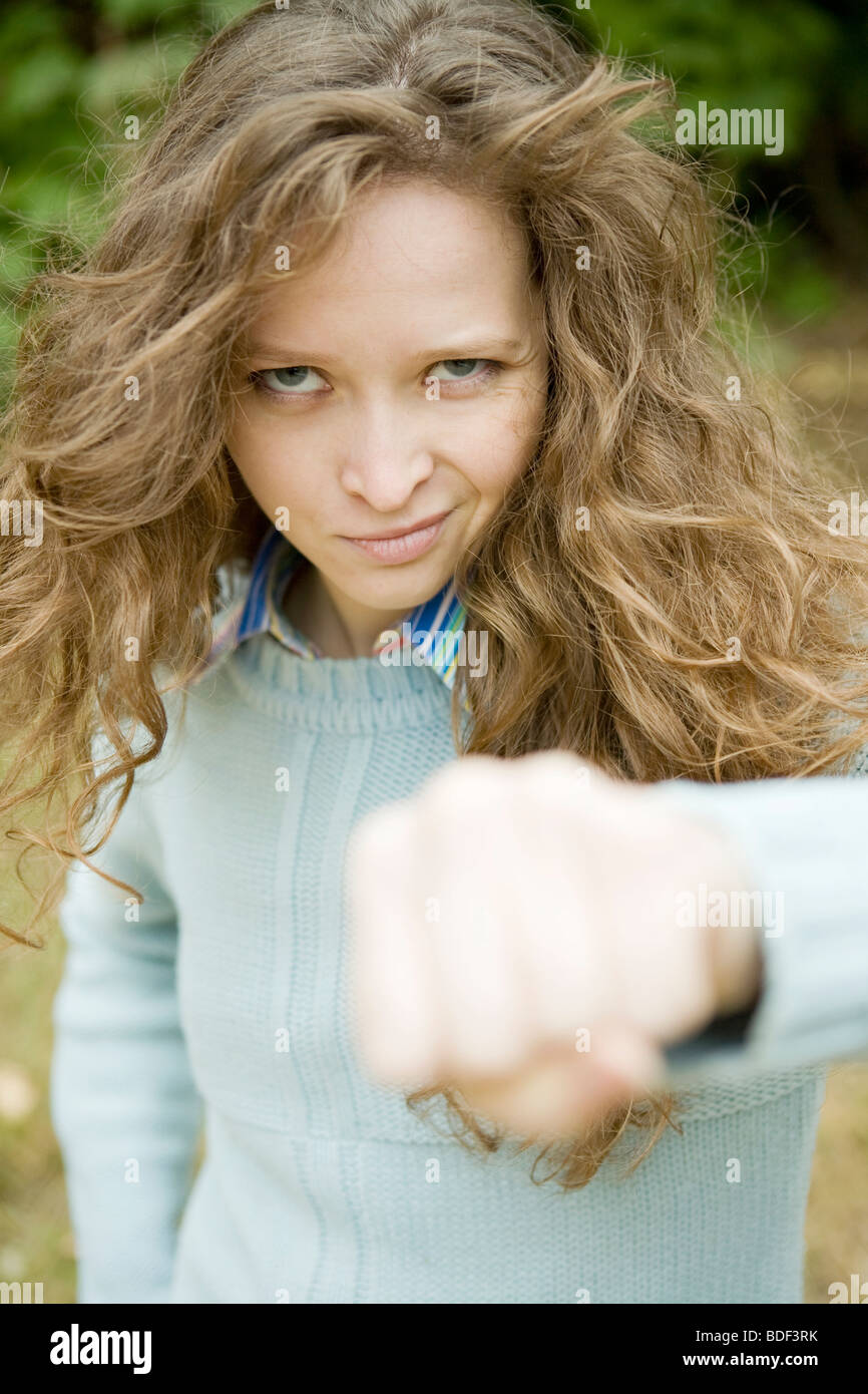 Portrait of an attractive young aggressive female punching Stock Photo ...