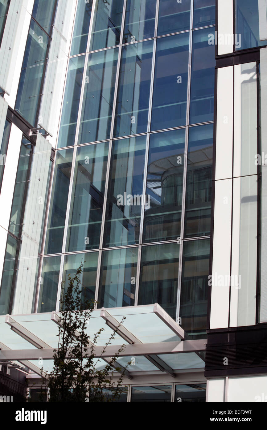 Reflection in the fornt of a modern office building Spinningfields ...
