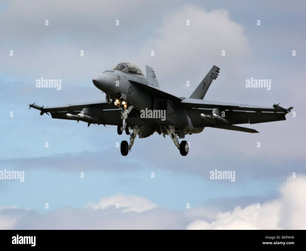 American Boeing FA-18 Super Hornet Jet landing with dynamic cloud ...