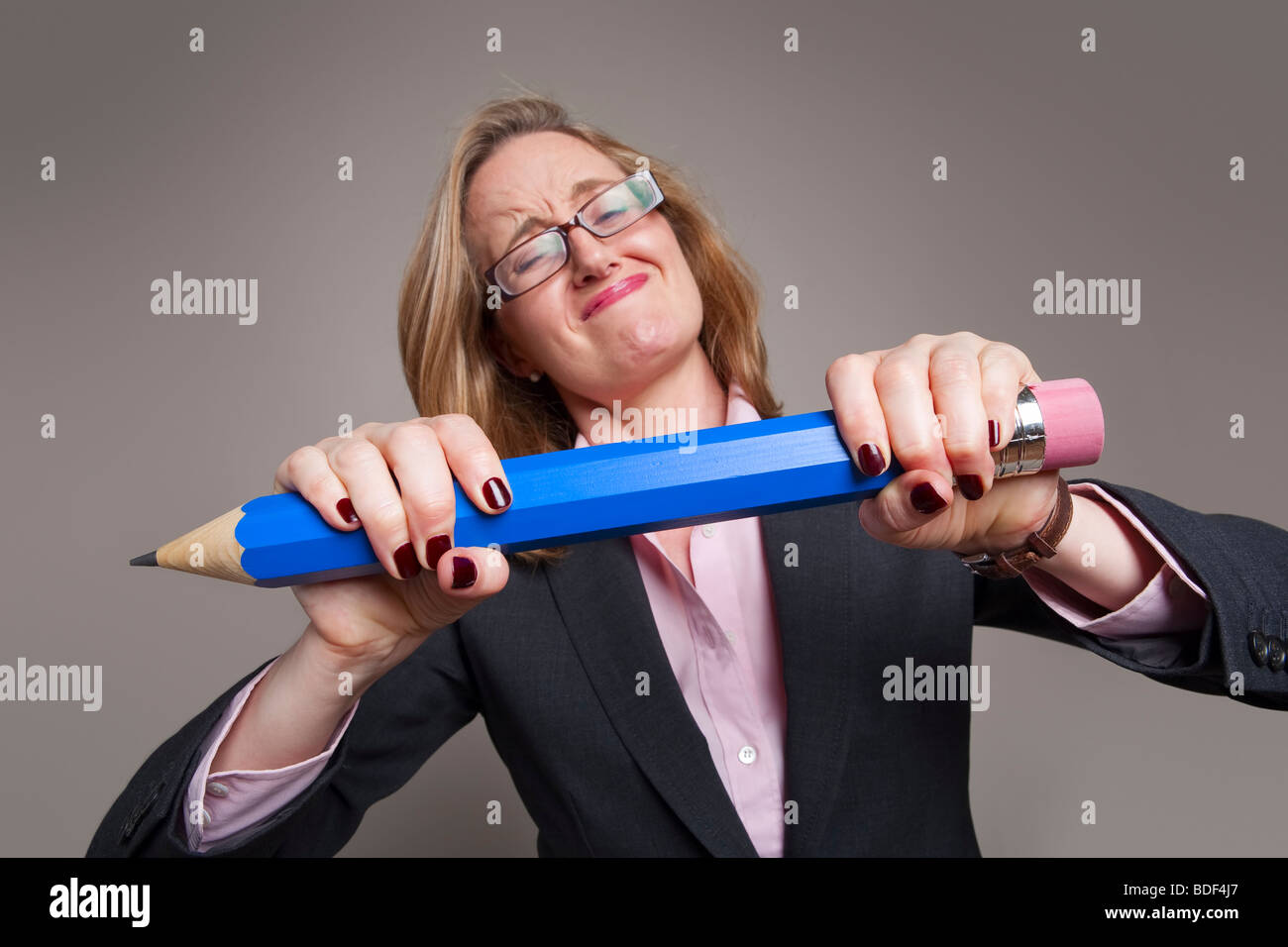 Woman snapping pencil hi-res stock photography and images - Alamy